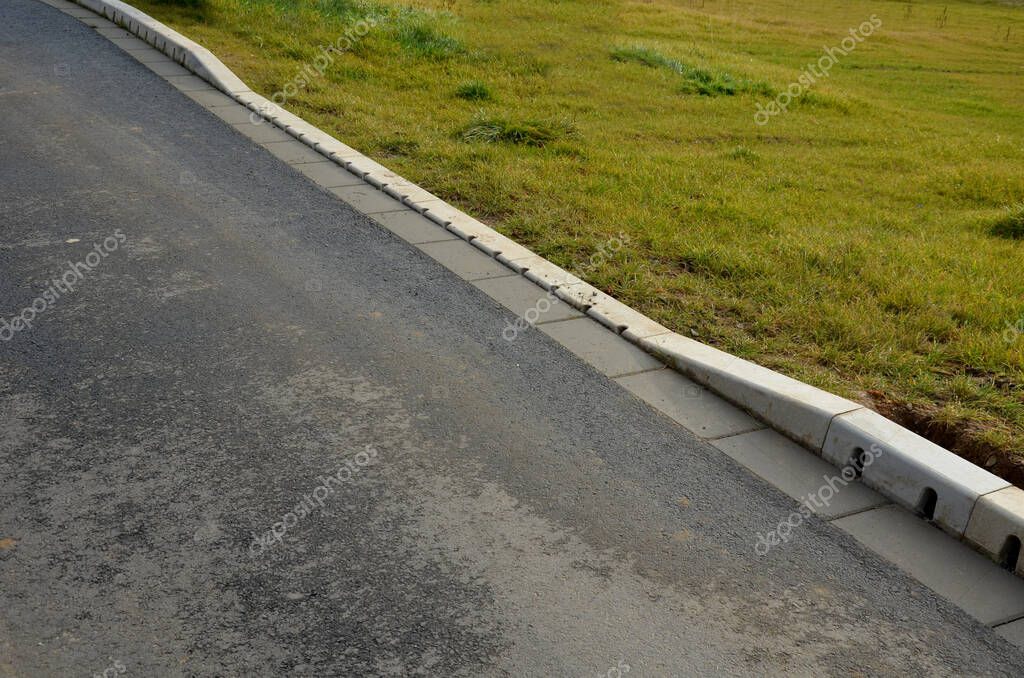 drainage hidden on the edge of an asphalt road Drainage system hidden ...