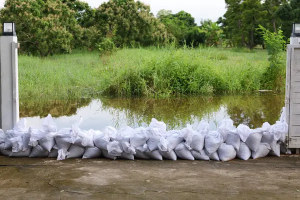 Sandbag for flood protection. A pile or wall of sandbags at the front ...