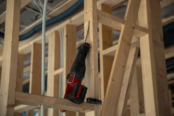 Wooden studs and beams form the structure of a house under construction ...
