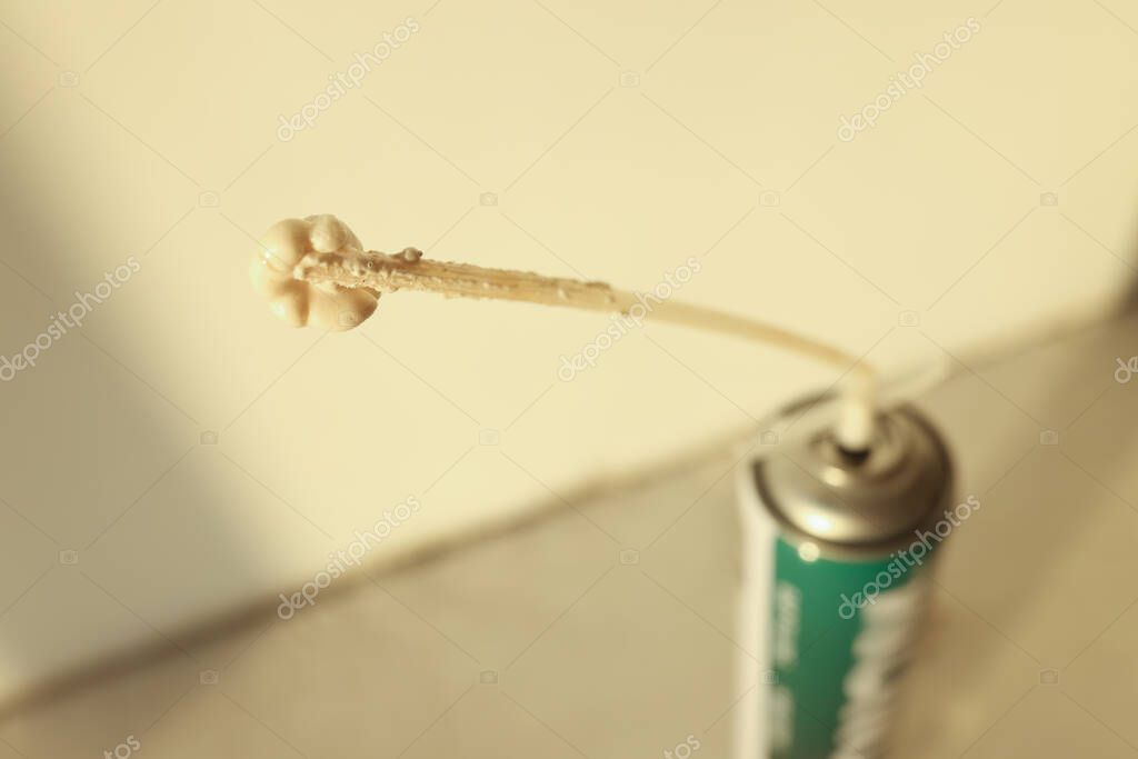 Polyurethane foam is on the floor, a close-up. Installation, fixation ...