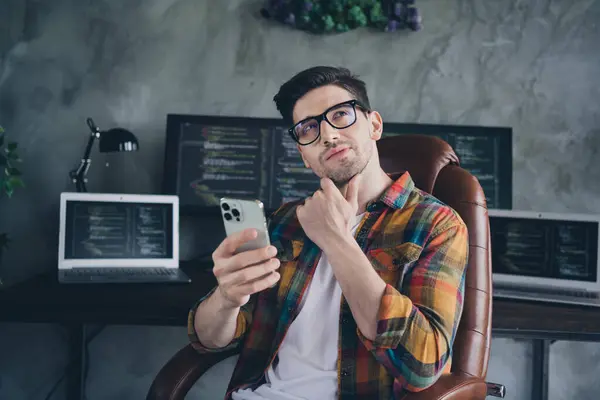 Portrait of minded clever it company executive sit chair hold smart ...