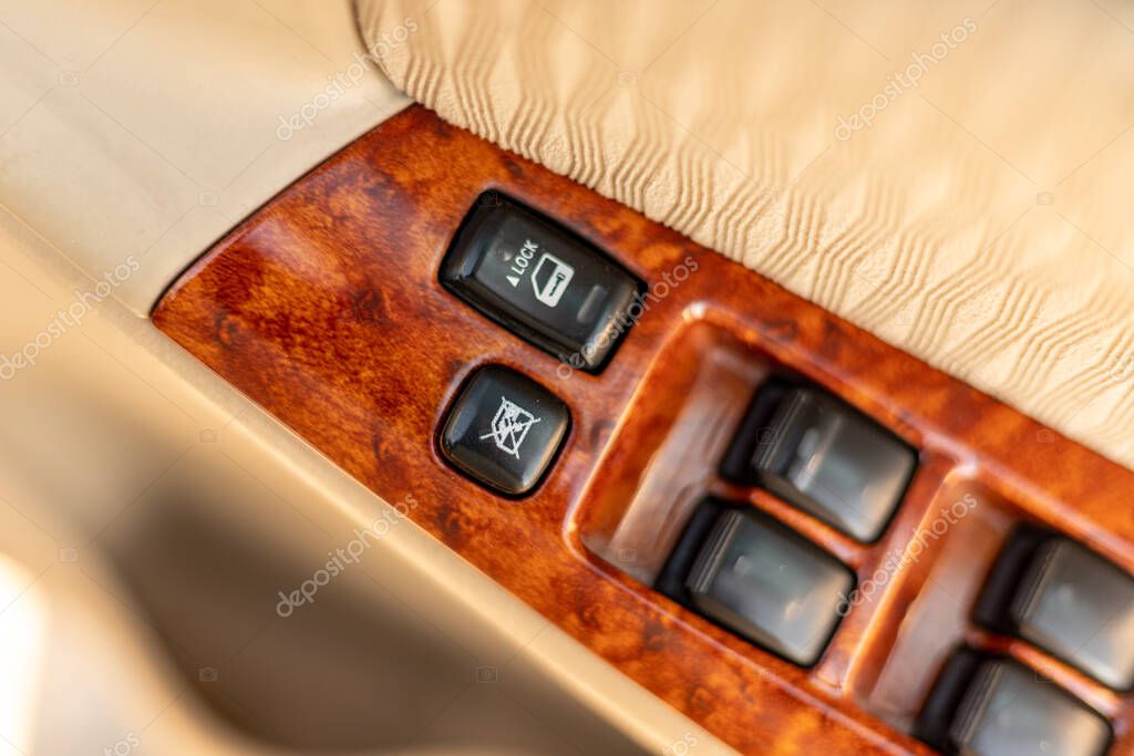 Car's window lock and unlock button on the arm of a driver side door 2023