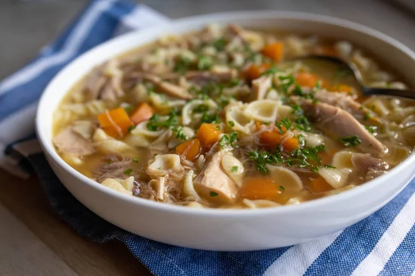 Chicken noodle soup with shell noodles and vegetables - Stock Image ...