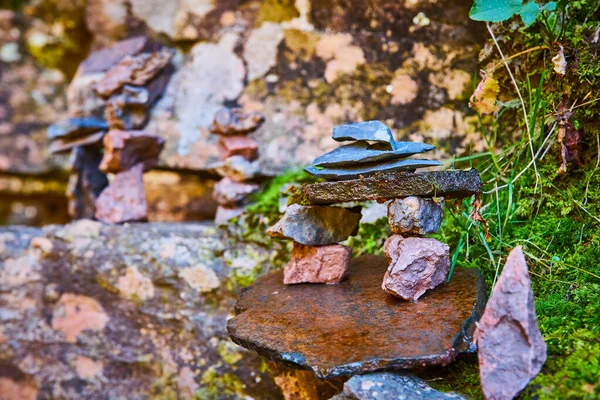 Image of Beautiful small stone stack cairn forming bench against lichen ...