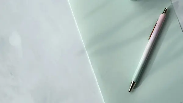 Minimal business feminine flat lay, soft light green paper and pen on ...