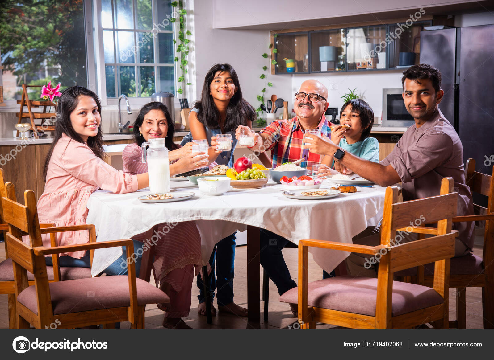 Happy Multi Generation Asian Indian Family Enjoying Lunch Together Home ...