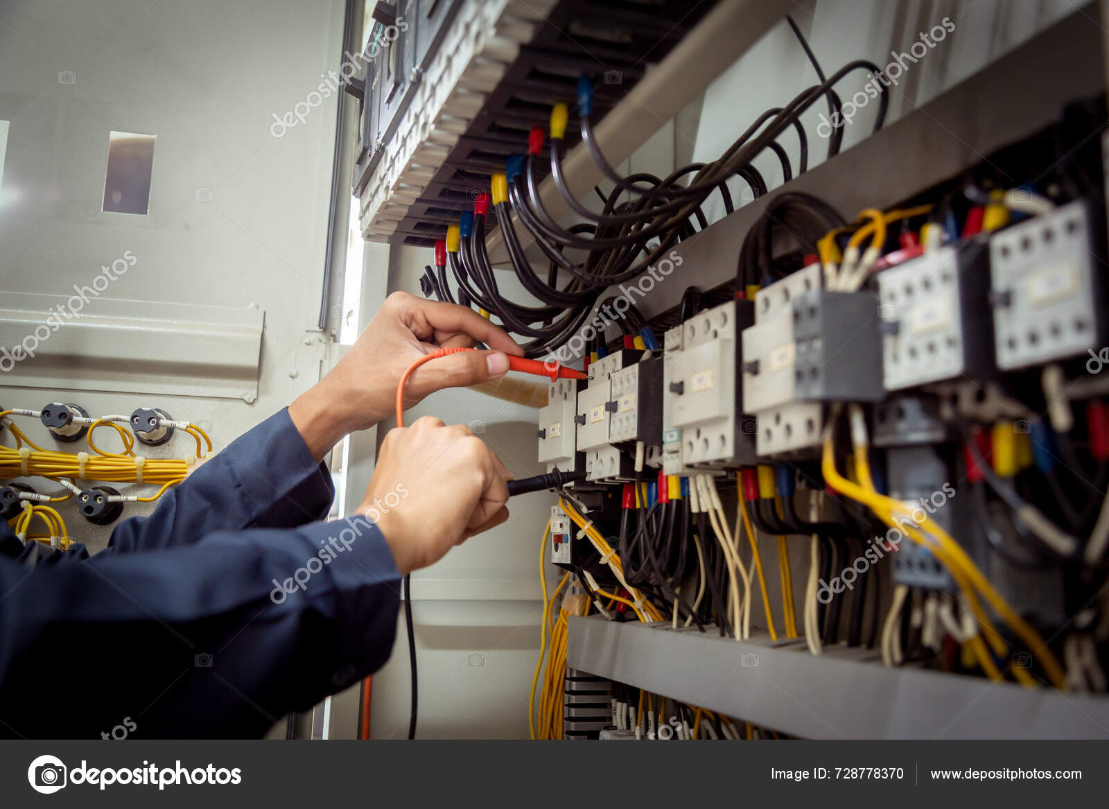 Electrical Engineer Using Measuring Equipment Checking Electric Current ...