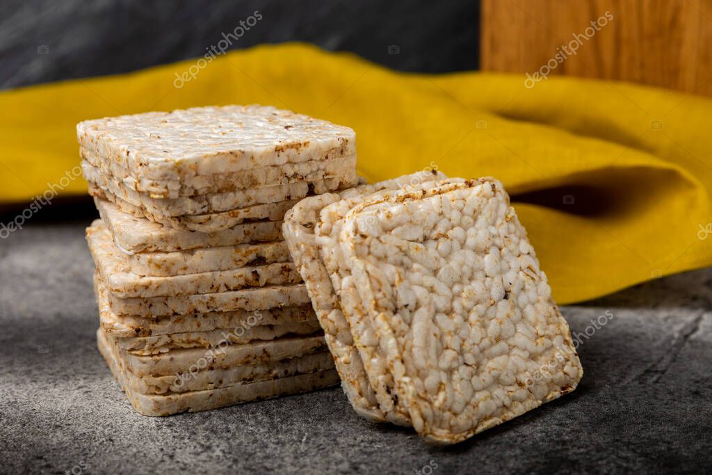 puffed rice bread on black texture background. Healthy crunchy snack ...