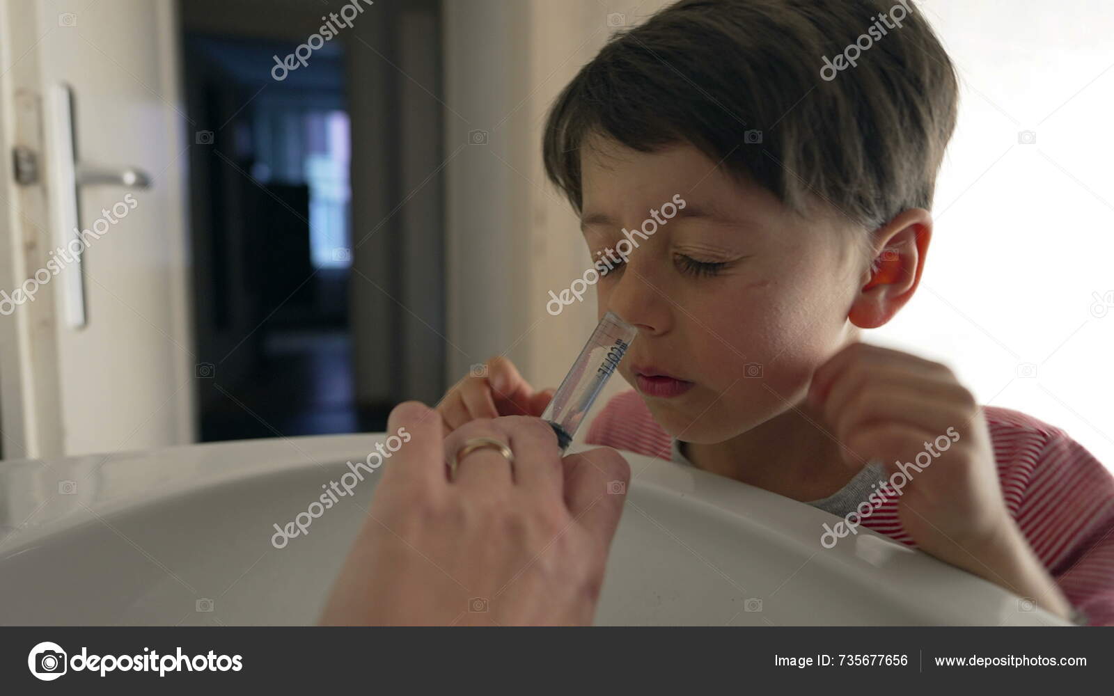 Parent Assisting Child Nasal Hygiene Using Nasal Spray Demonstrating ...