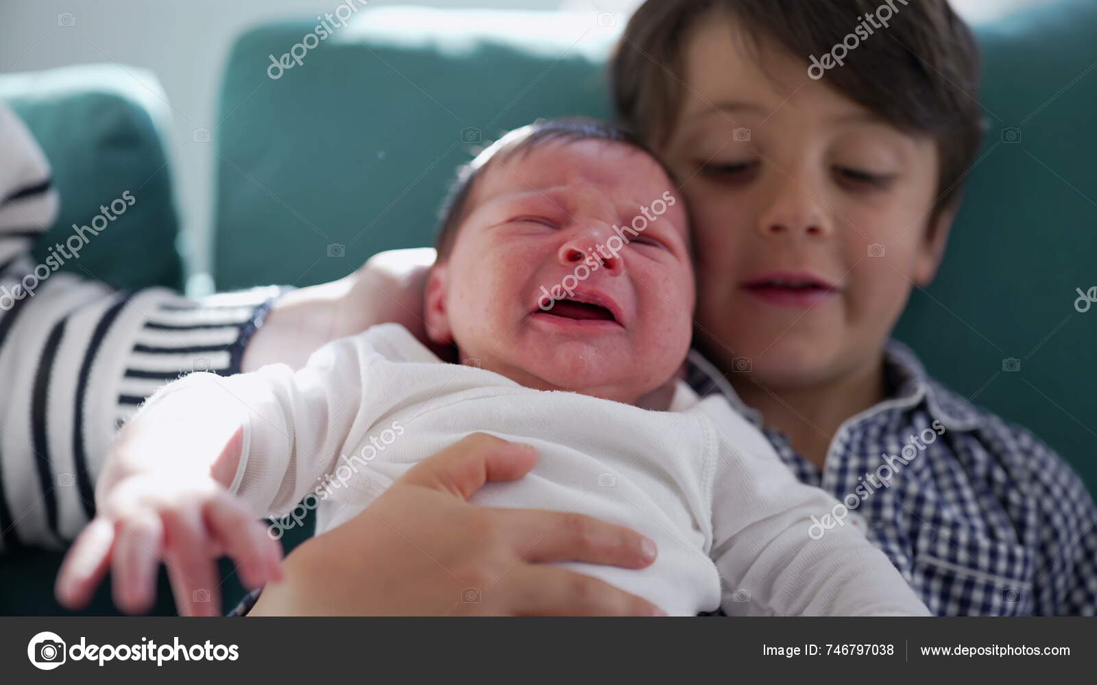 Young Boy Holding Crying Newborn Sibling Closely Highlighting Emotional ...