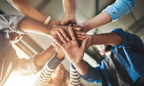 Coming together to achieve success. a group of creative businesspeople ...