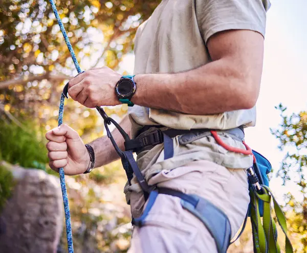 Rock climbing, mountain and man with rope and harness for adventure ...
