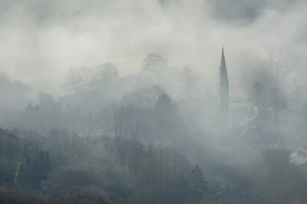Trees, and mist. Bamford Edge landscape vignette during a winter ...