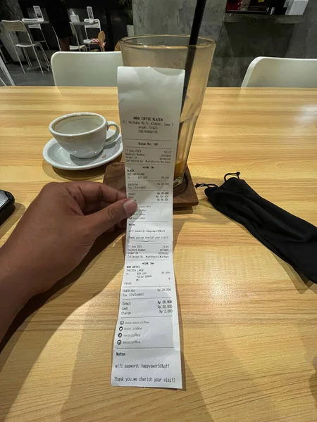 receipt. Close-up of male hands with a utility bill, a lot of checks ...