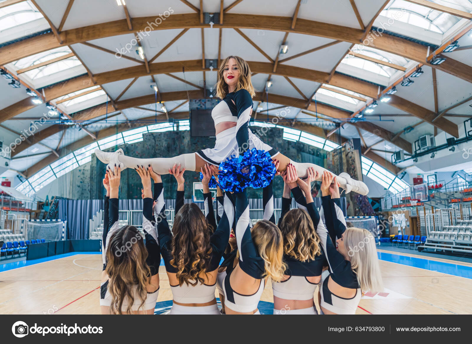 Group Cheerleaders Captured Dynamic Athletic Moment Performing Split ...