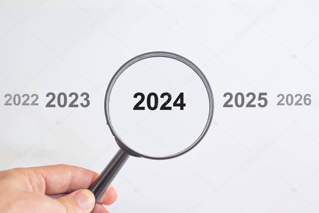 year 2024 in a magnifying glass.past and future years.new year idea ...