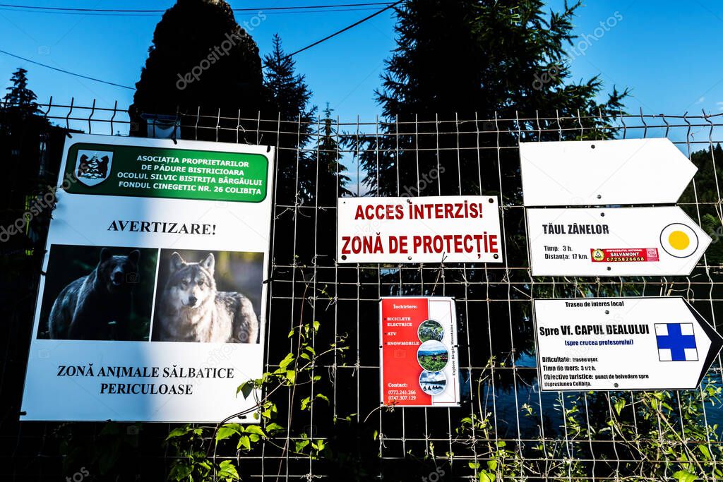 COLIBITA, ROMANIA - JUNE 26, 2023: Signpost with various hiking trail ...