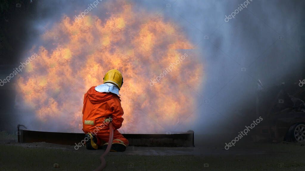Firefighter Rescue training in fire fighting extinguisher. Firefighter ...