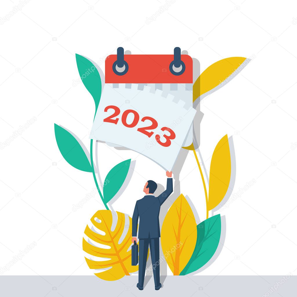 Adiós 2023. Un empresario arranca una hoja de calendario del año ...