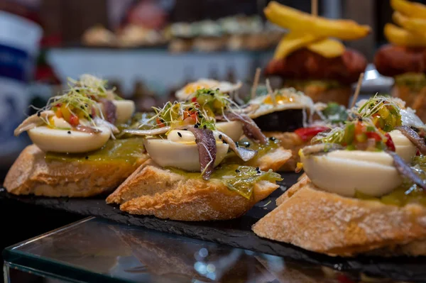 Typical snack of Basque Country, pinchos or pinxtos, small piece of ...