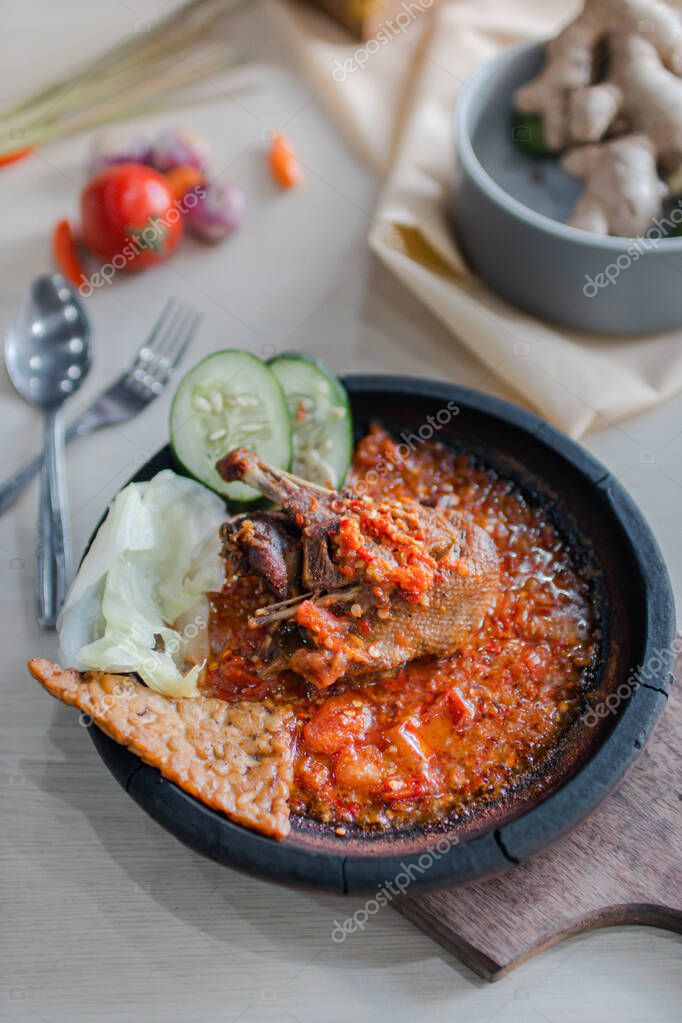 Sambal gami ayam goreng or fried chicken with sambal cooked in ...