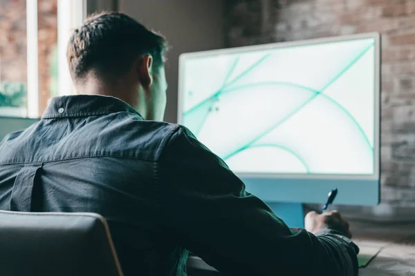 Back view handsome young businessman working with computer remotely ...