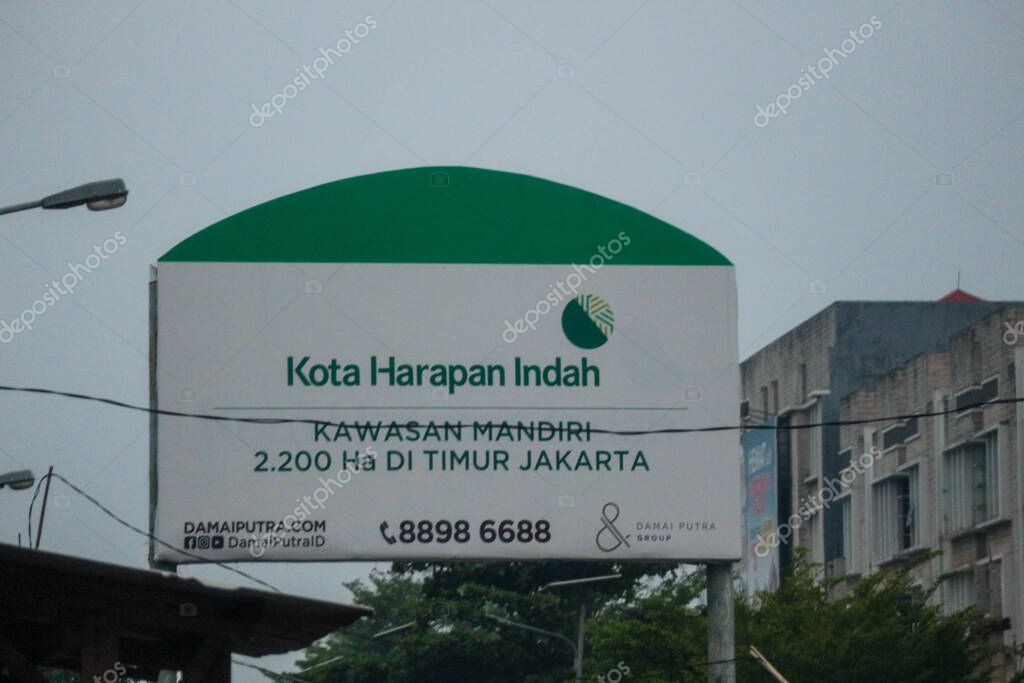 Jakarta, Indonesia in November 2022. Back view of a motorcyclist driving on a busy street on the ...