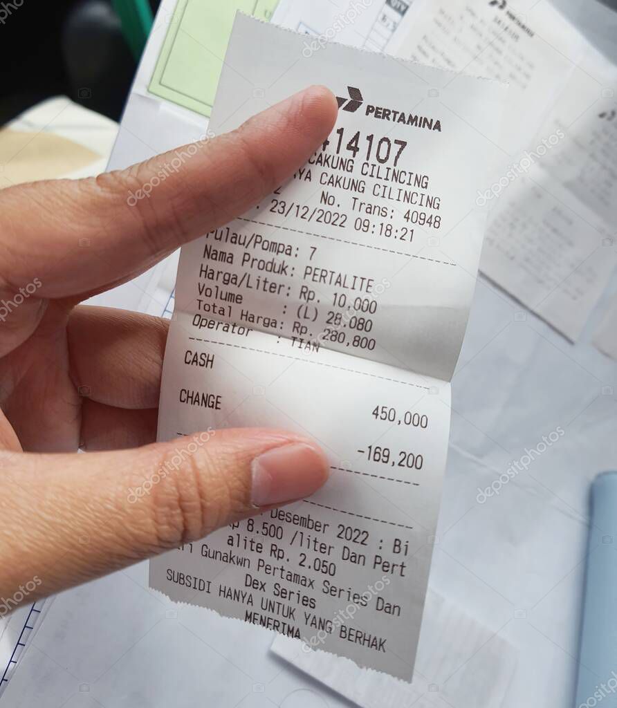 West Java, Indonesia in January 2023. A hand is holding a fuel purchase ...