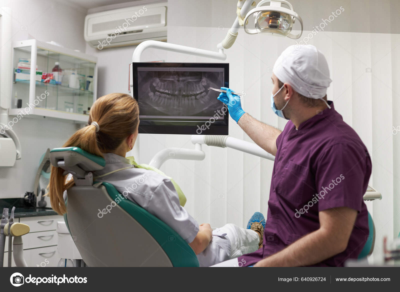 Rear View Orthodontist Dentist Pointing Digital Ray Orthopantomogram ...