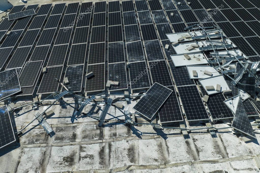 Aerial view of damaged by hurricane wind photovoltaic solar panels ...
