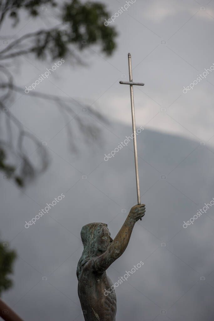 "Jesus holding up a cross on Mount Monserrate holding a cross with ...
