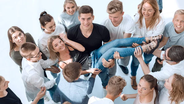 close up. merry team rocking their leader. - Stock Image - Everypixel