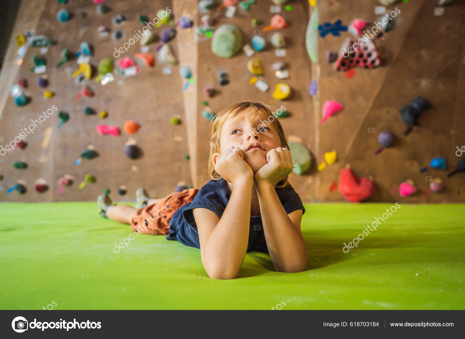 Boy Resting Climbing Rock Wall Indoor — Stock Photo © YAY_Images #618703184