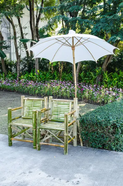 Bamboo bench with umbrella in public park, Thailand. - Stock Image ...