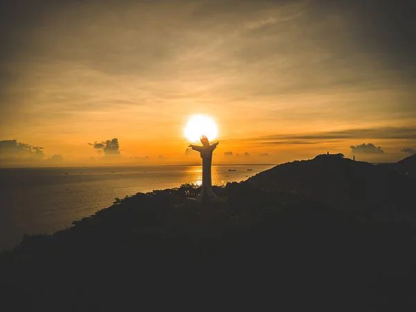 Top view of Vung Tau with silhouette statue of Jesus Christ on Mountain ...