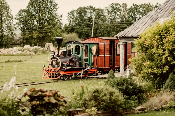 The old small steam train stands proudly on display in the museum, a ...