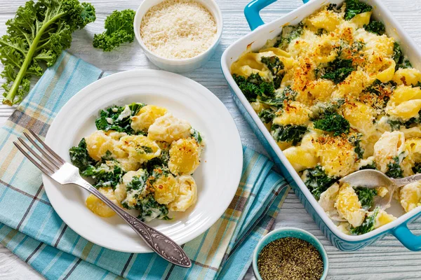 cheesy baked shell pasta with green leafy kale topped with crispy ...