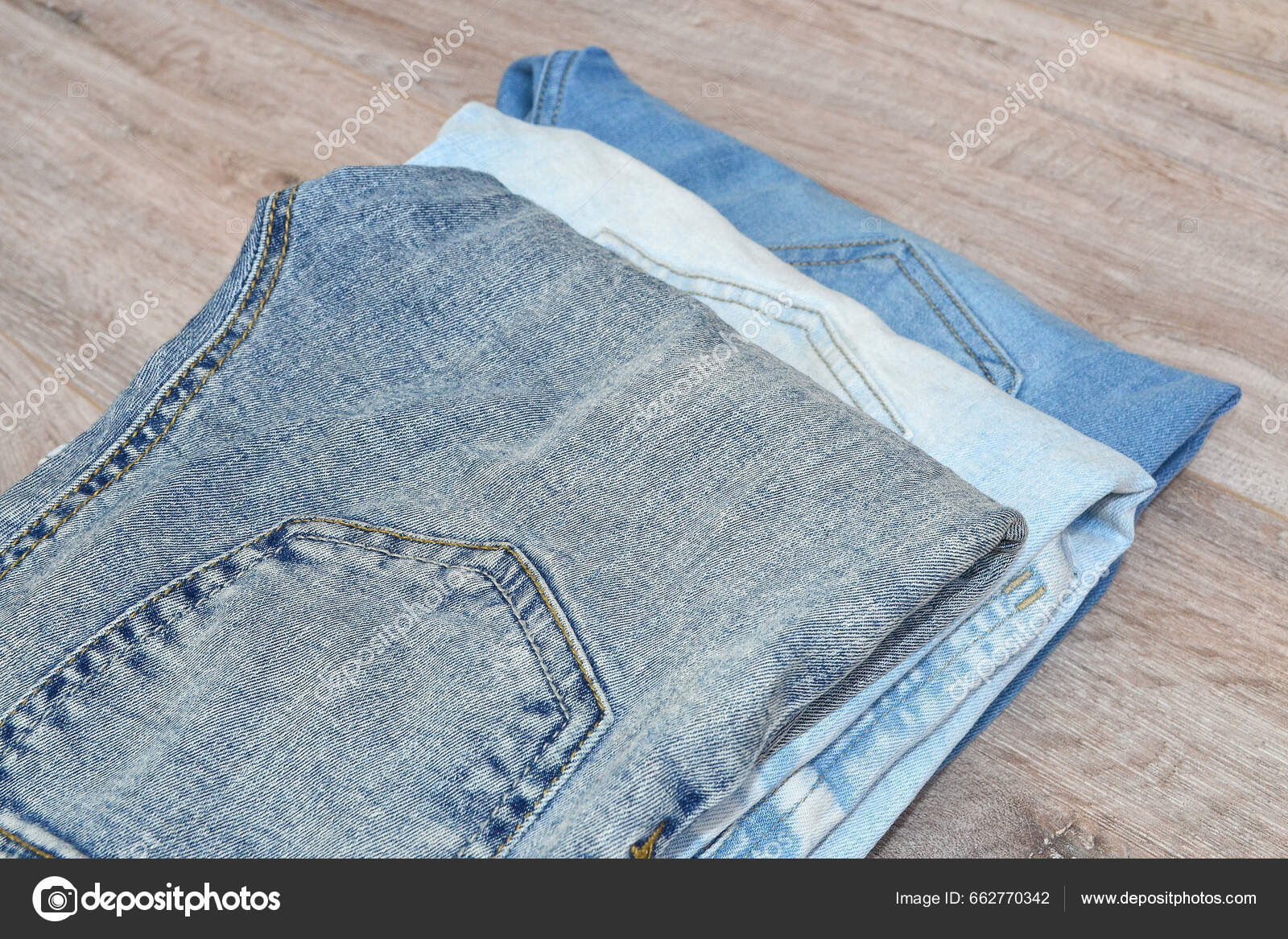Three Pairs Blue Jeans Lie Floor — Stock Photo © garmony #662770342