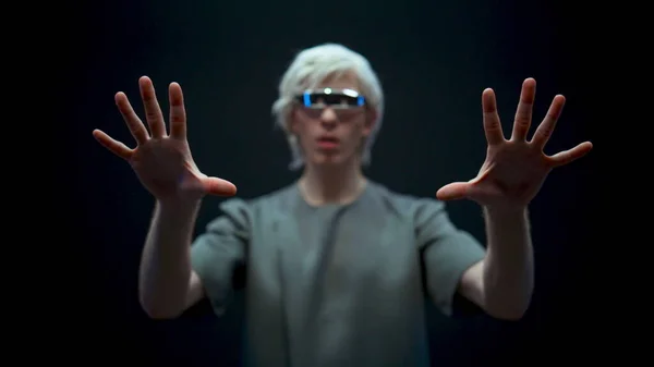 Focused man moving rotating virtual objects. Next generation guy ...