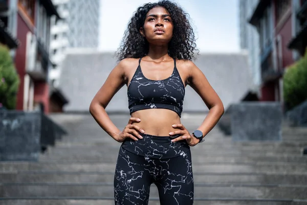 A strong athletic. female sprinter. African women standing at city ...