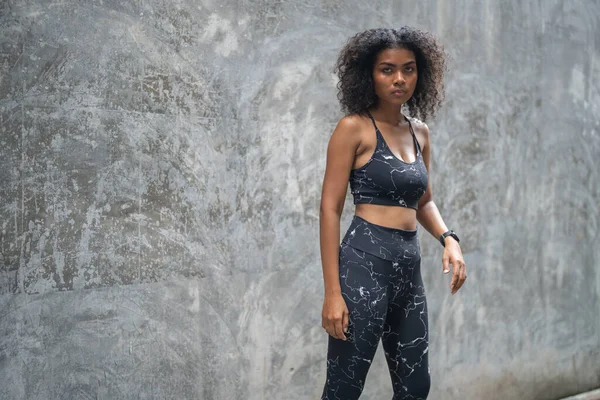 A strong athletic. female sprinter. African women standing at city ...