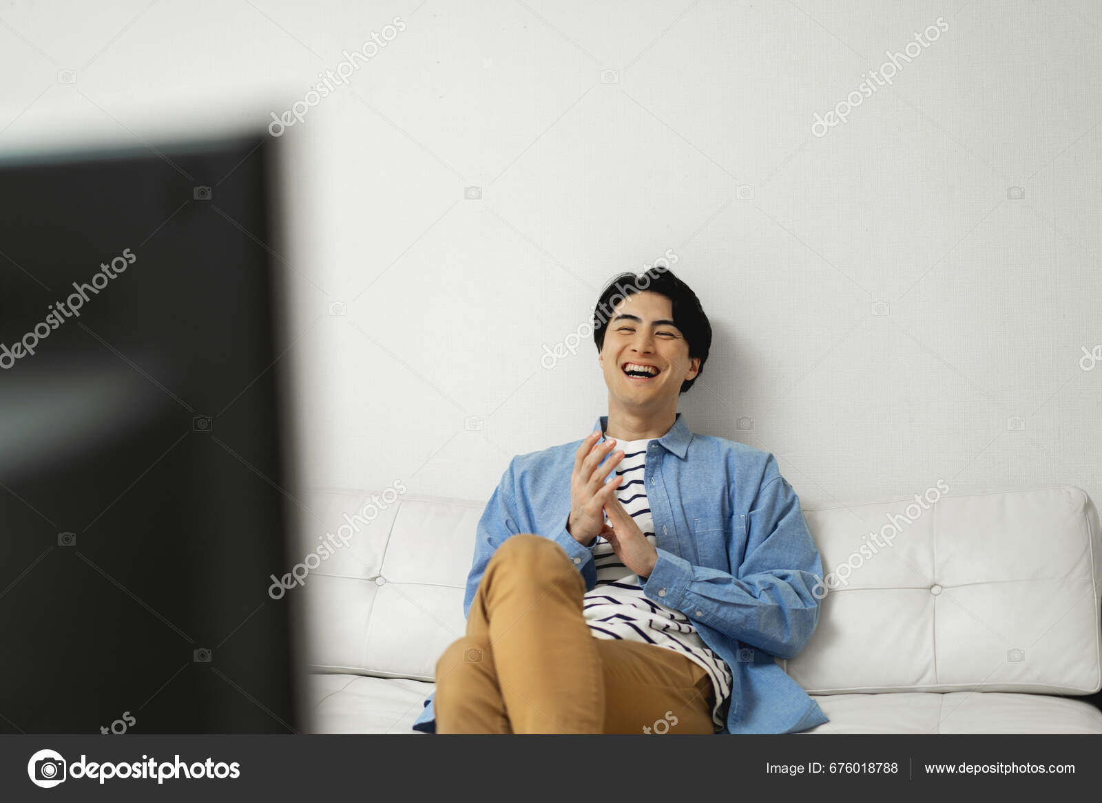 Young Asian Male Man Watching Home — Stock Photo © Paylessimages #676018788