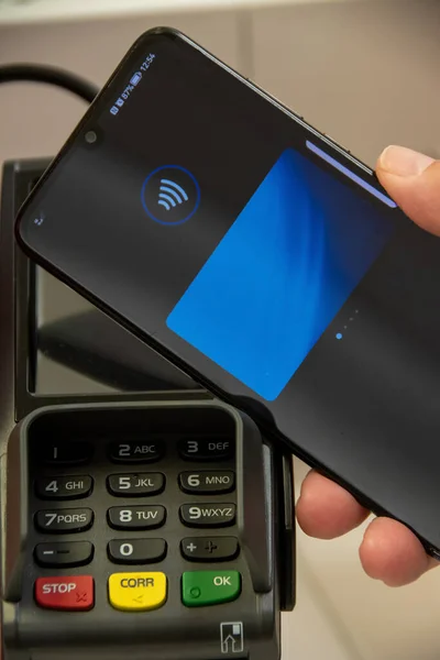 Smartphone close up being used for a contactless NFC payment. Close up ...