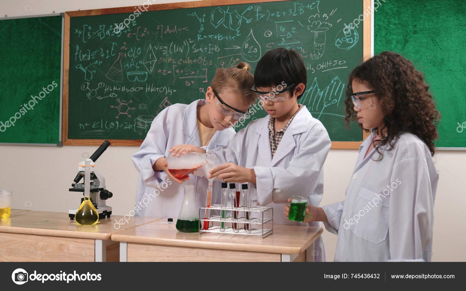 Children Doing Experiment Science Lesson While Standing Blackboard ...